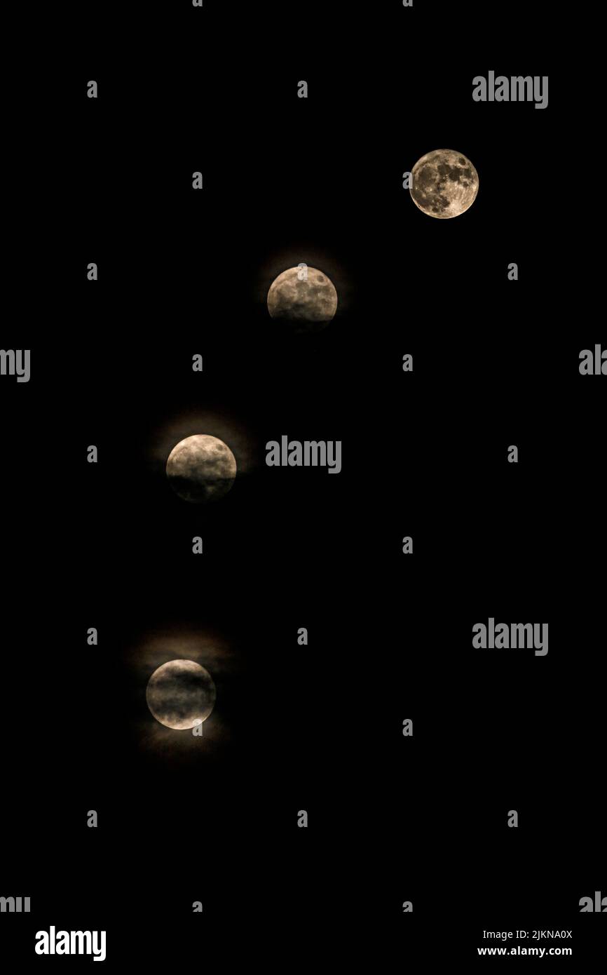 The vertical shot of phases of a moon on a black background Stock Photo ...