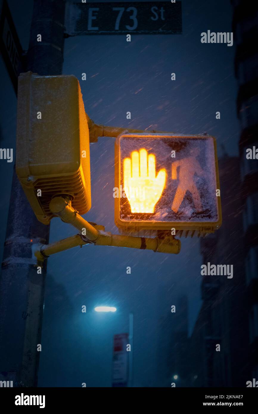 A vertical closeup shot of a pedestrian traffic light telling to stop ...