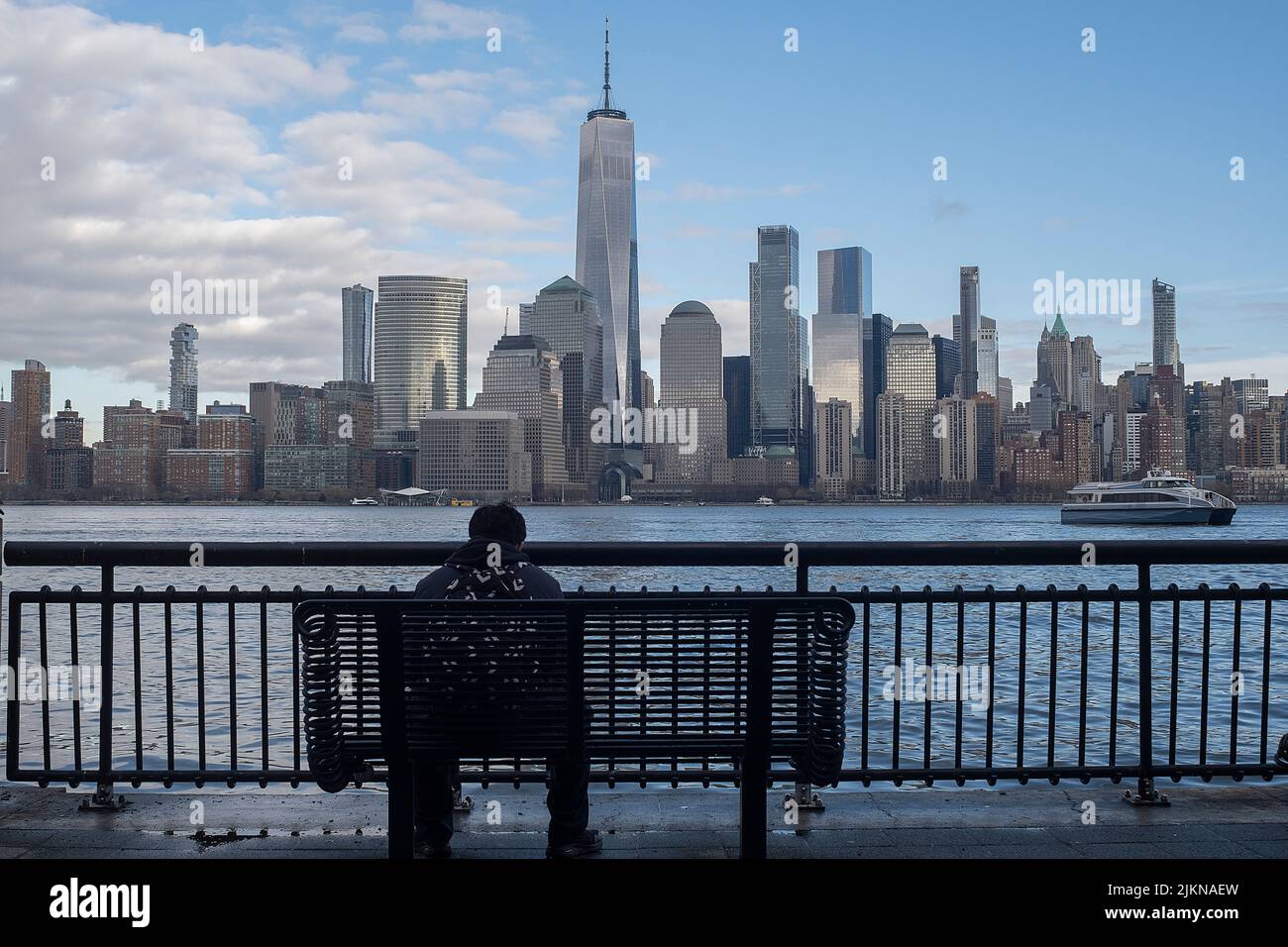 A person sitting on a bench overlooking New York, USA Stock Photo - Alamy