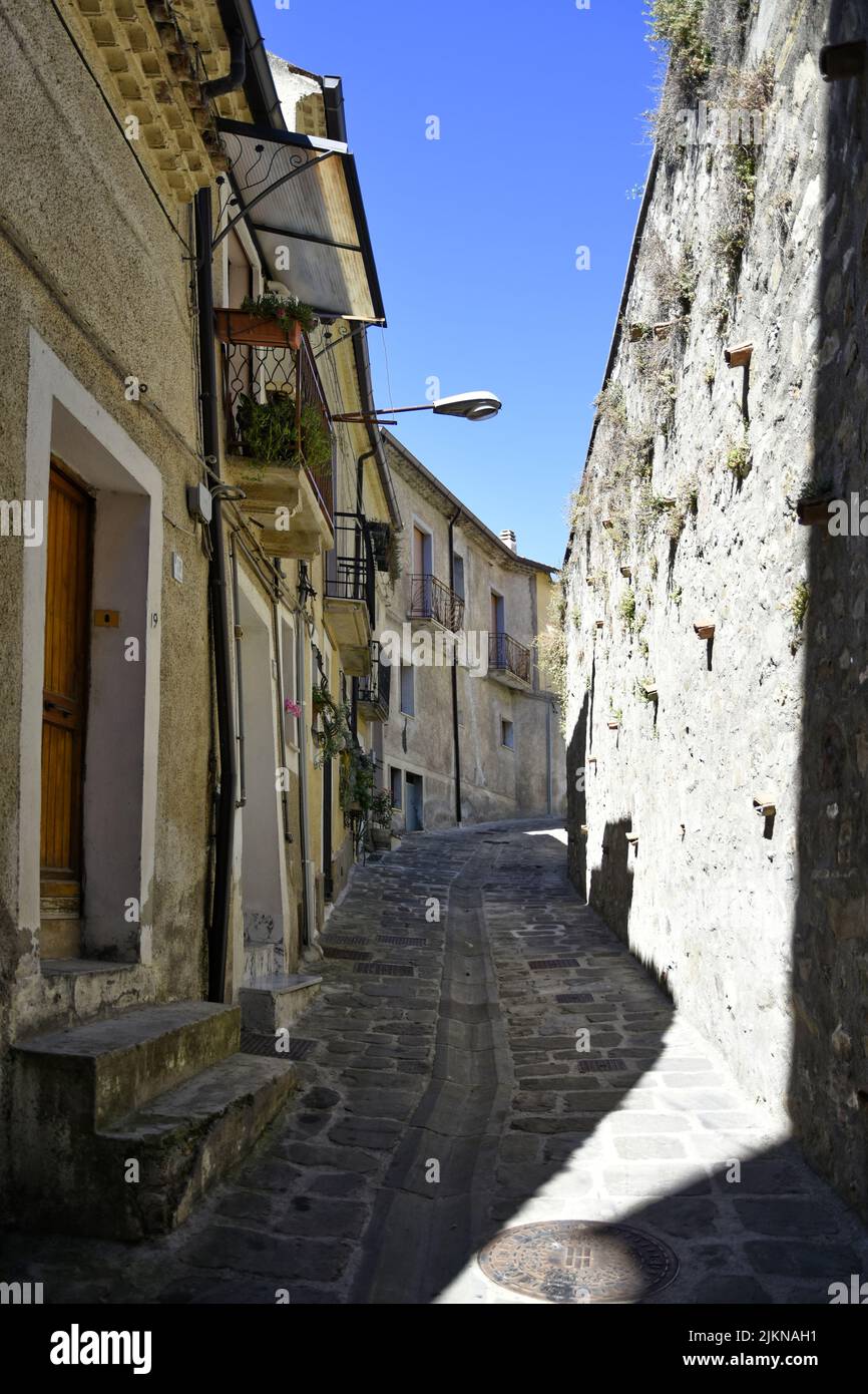 A vertical shot of a narrow street in Calvello village in the ...