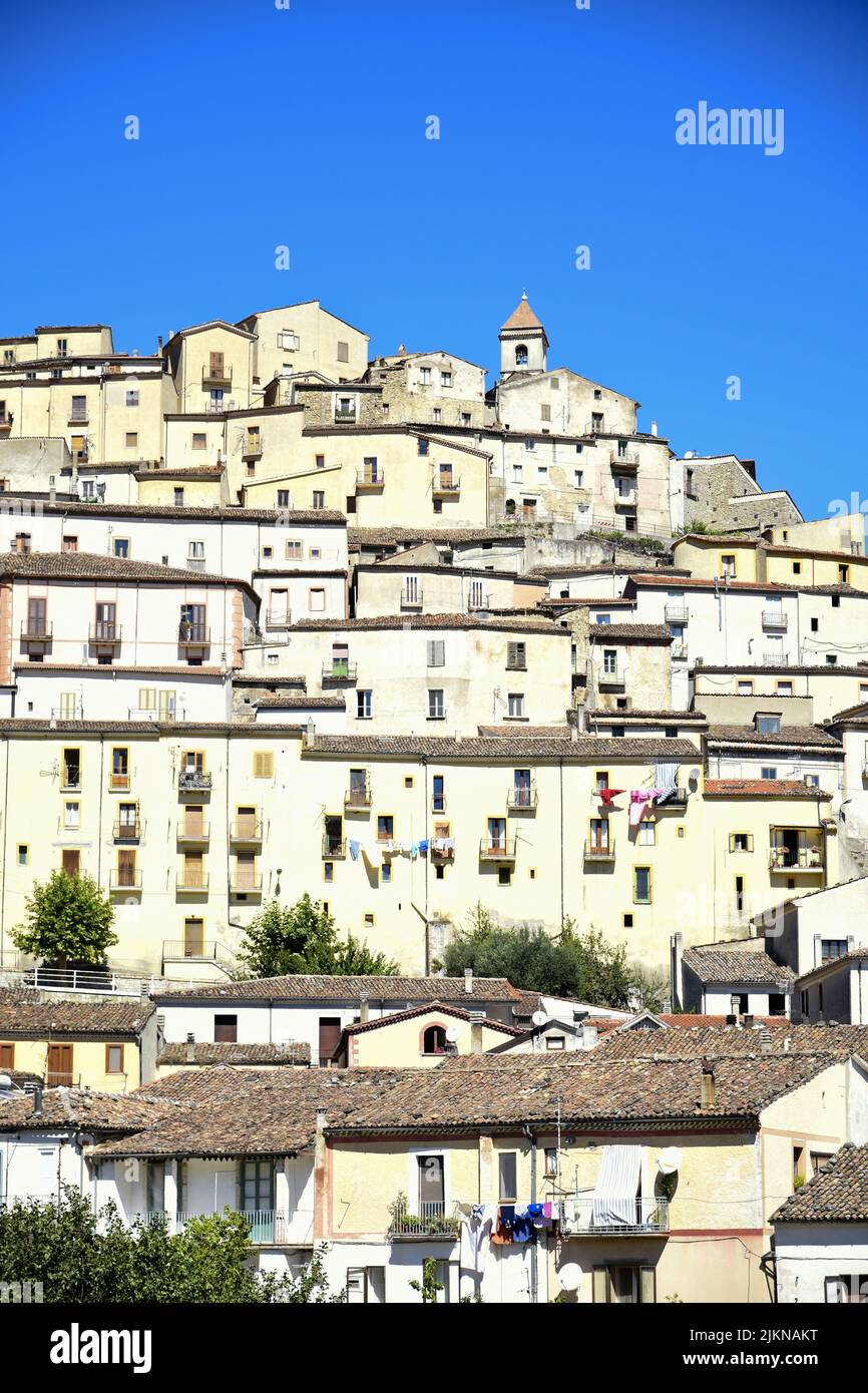 A vertical shot of the white buildings of Calvello village in the ...