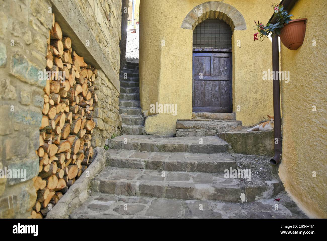 A narrow old street paved with stone. Stairs leading up, Castelmezzano ...