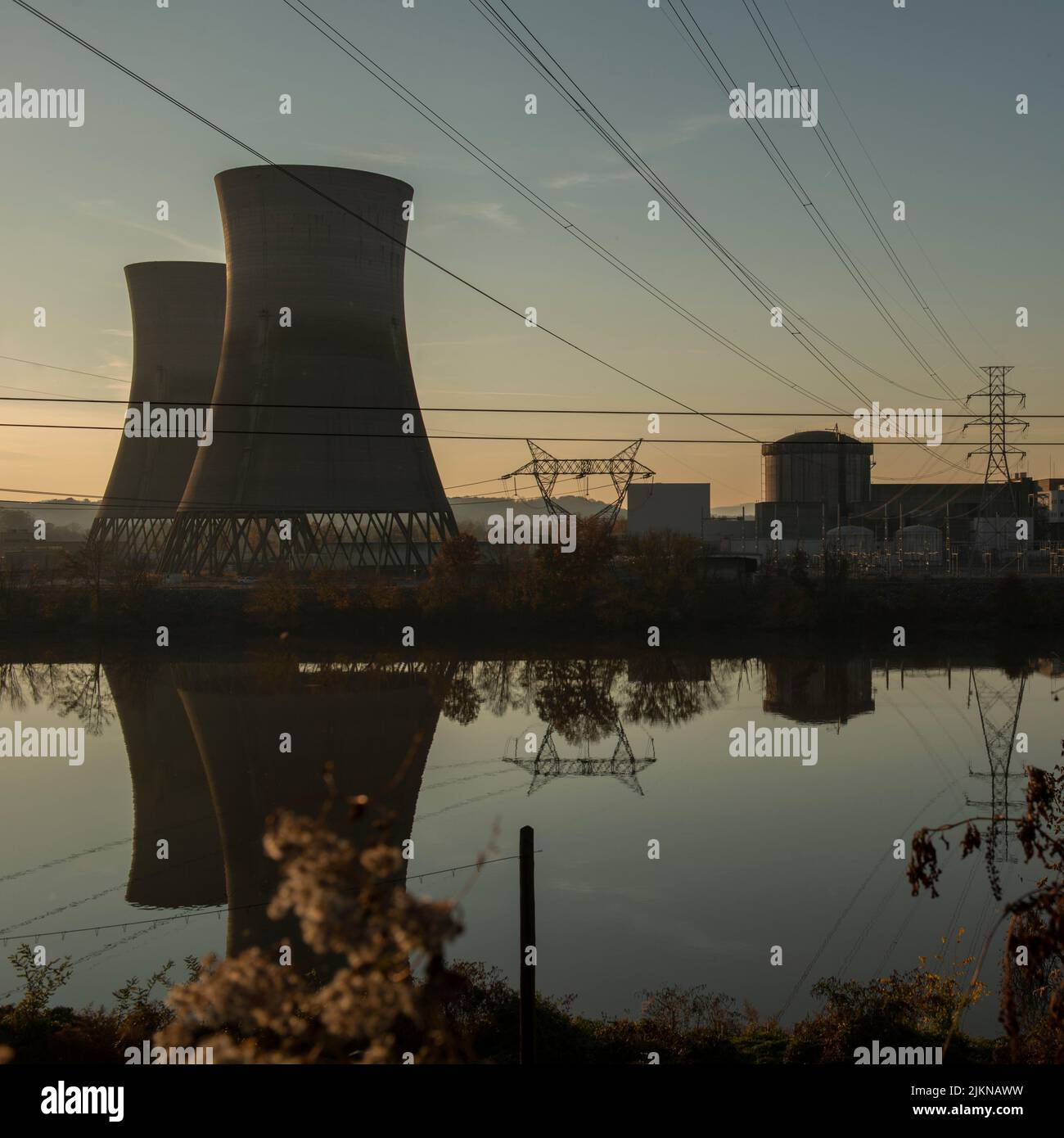 A scenic view of Nuclear power plant reflecting on the water surface ...