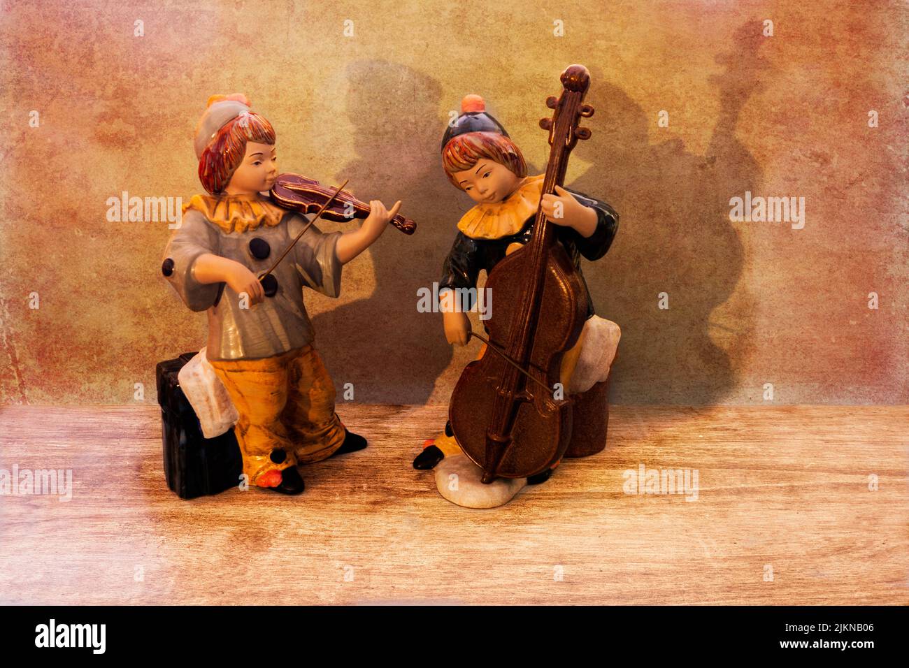 A still life with two ceramic musicians playing violin and cello Stock ...
