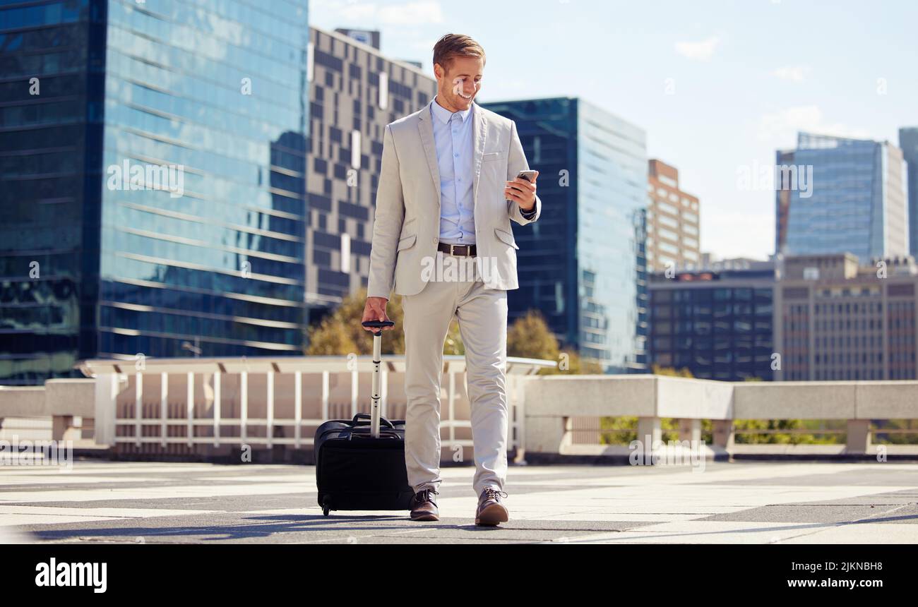 Getting work done on the go. a young businessman using a cellphone ...