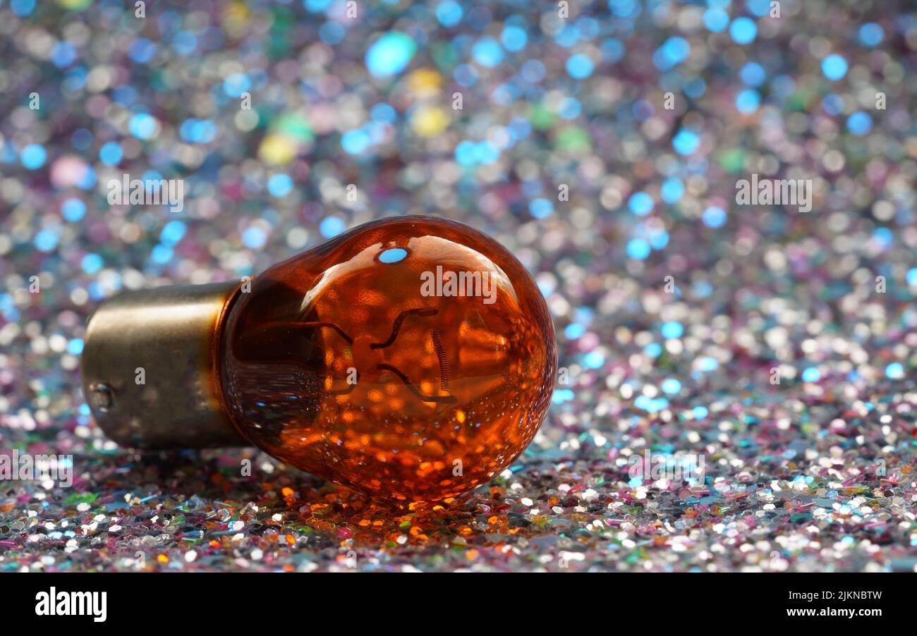 A decorative brown light bulb on a glowing ground Stock Photo - Alamy