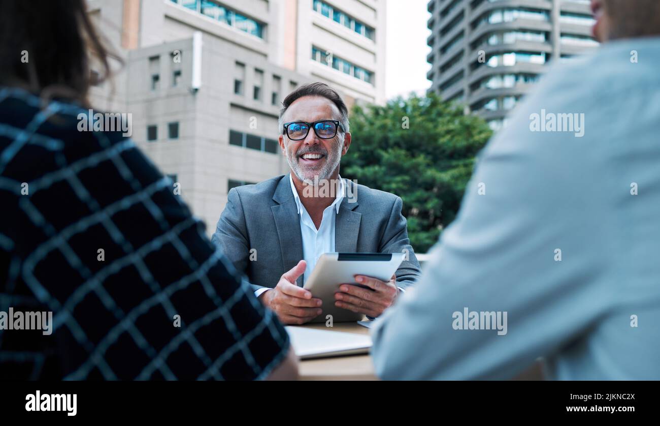 He sure does have big ideas to share. a mature businessman using a ...