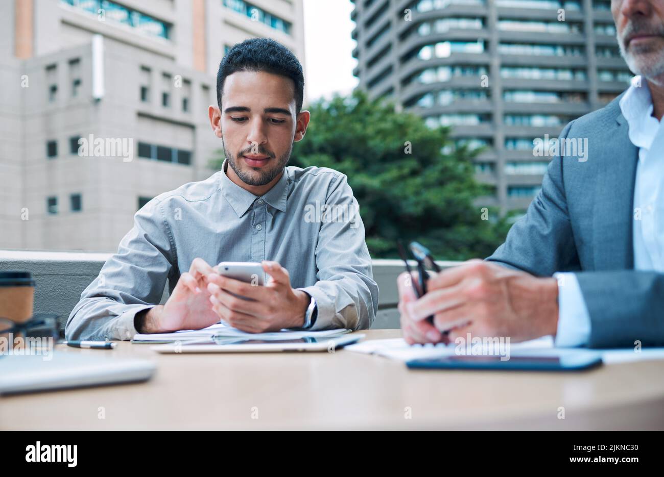 Man tapping phone on balcony hi-res stock photography and images - Alamy