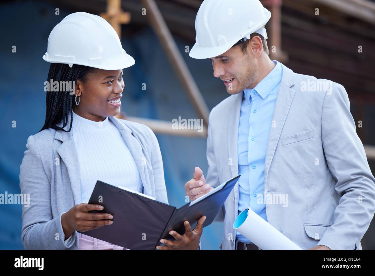 We can go ahead with these drawings. two coworkers looking over plans ...