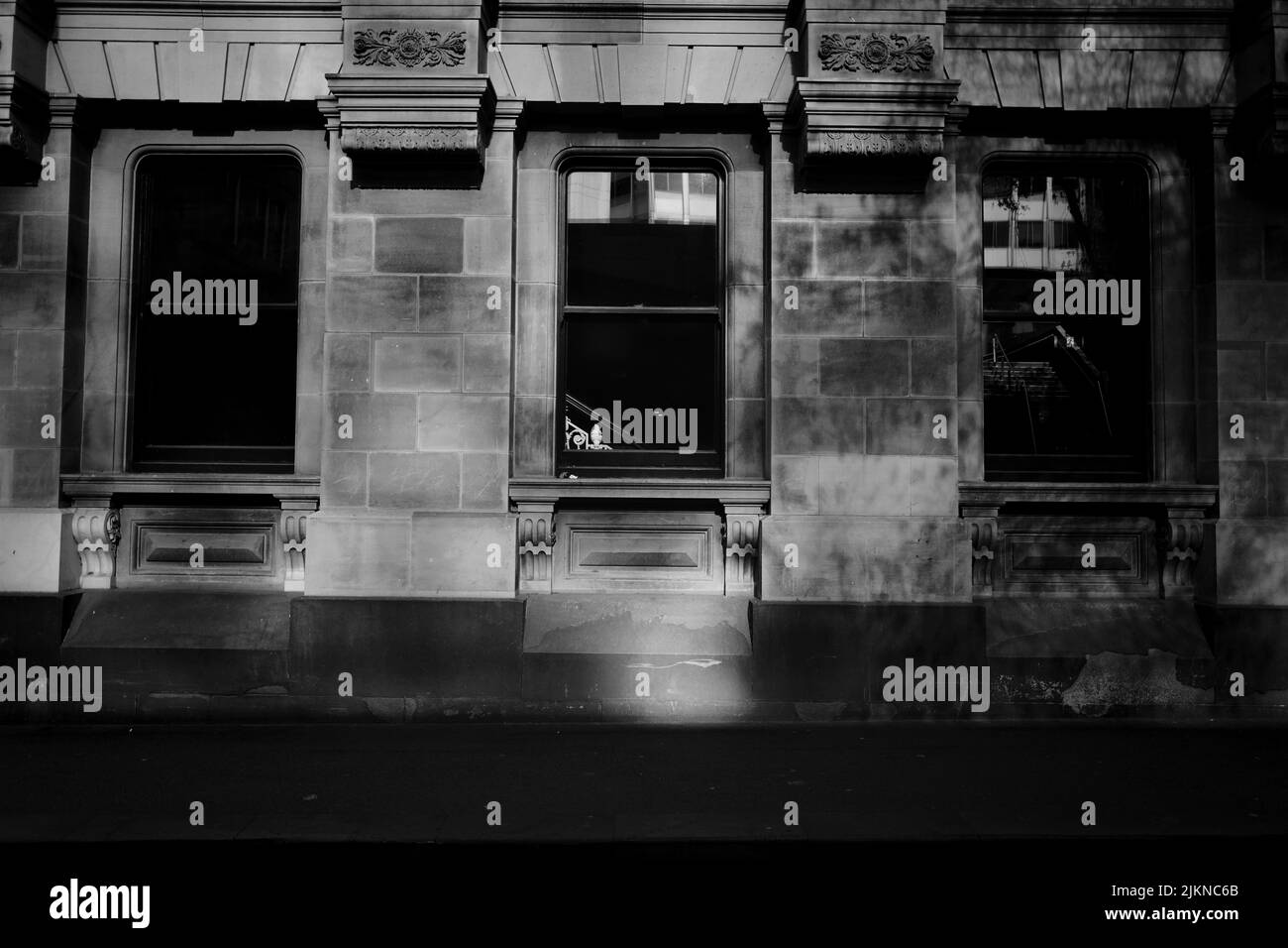 A grayscale of an old building with windows Stock Photo - Alamy