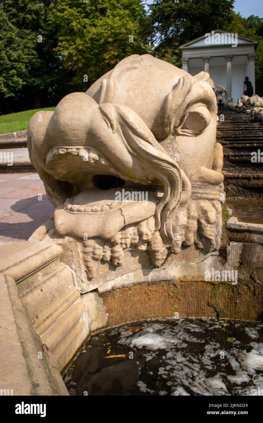 A selective of a dragon sculpture on a water pond in a park Stock Photo ...