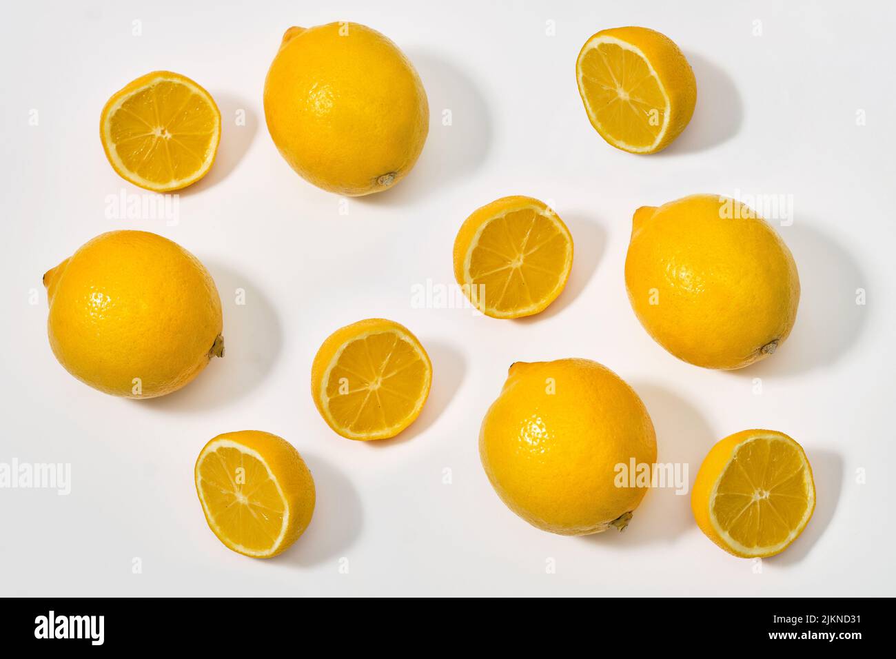 Lemon top view with halves and whole ripe lemons on white background ...