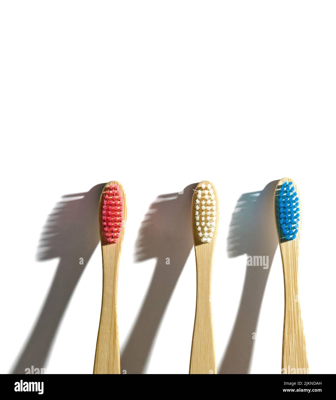A photo of eco-friendly bamboo toothbrushes with red, white, and blue ...