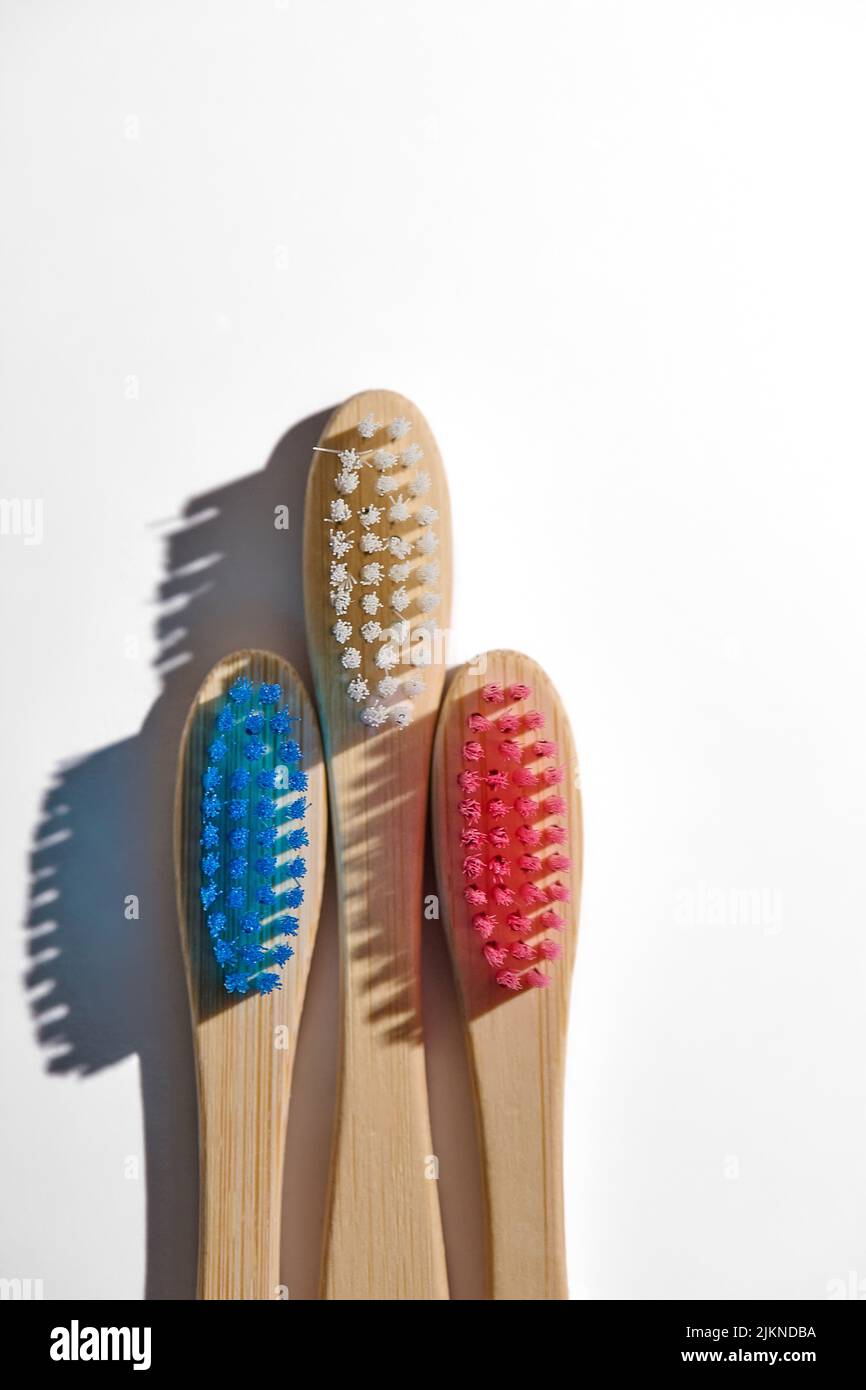 A photo of eco-friendly bamboo toothbrushes with red, white, and blue ...