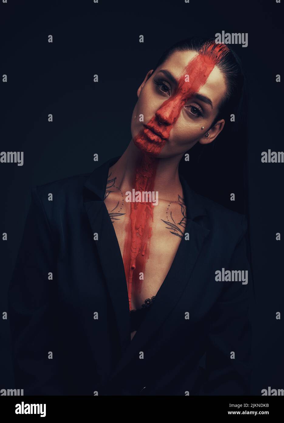 Her beauty is priceless. Studio shot of a young woman posing with paint ...