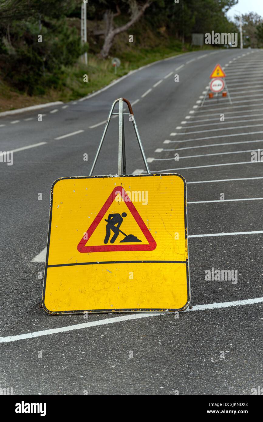 A vertical shot of road repair sign Stock Photo - Alamy