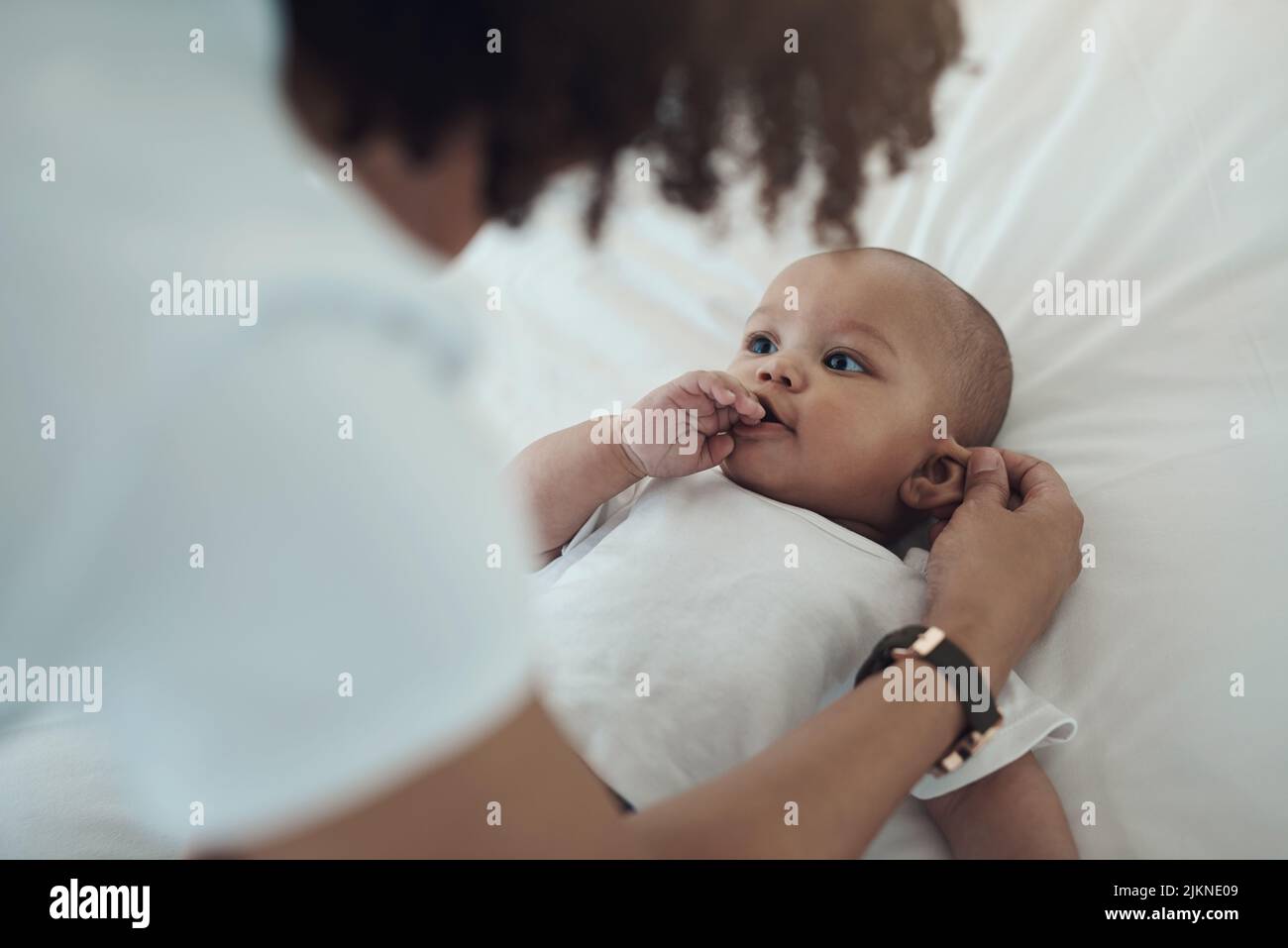 Baby touching her mother skin hi-res stock photography and images - Alamy