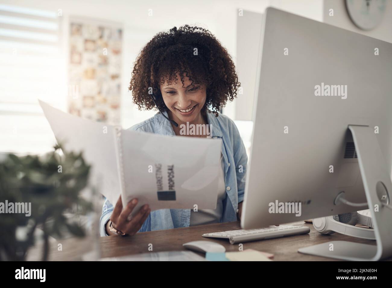 Making sure everything is correct. an attractive young woman sitting ...