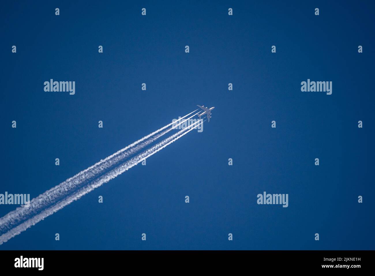 A photo of a plane with condensation tracks Stock Photo - Alamy