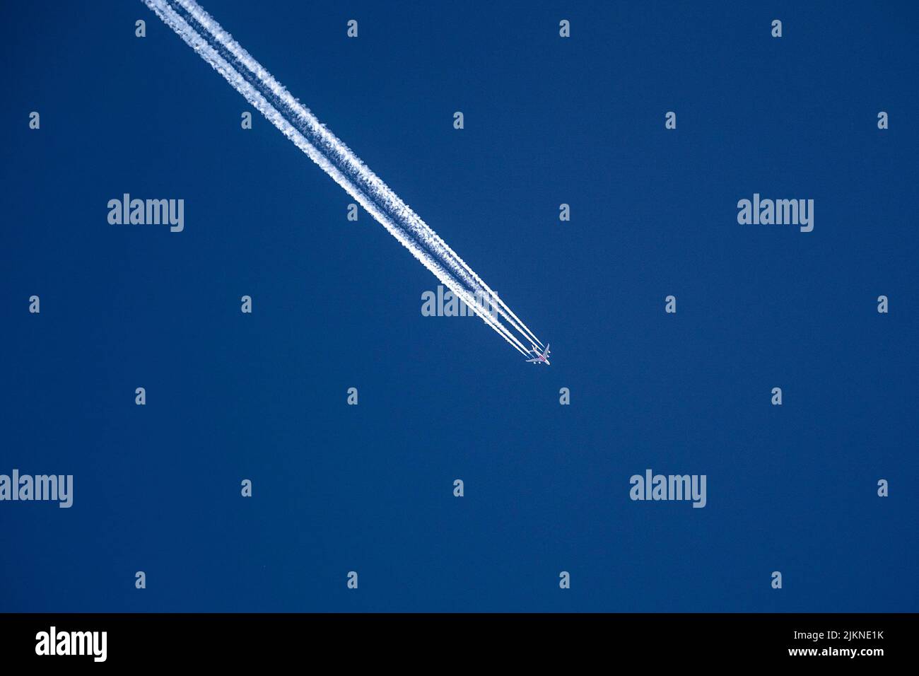 A photo of a plane with condensation tracks Stock Photo - Alamy