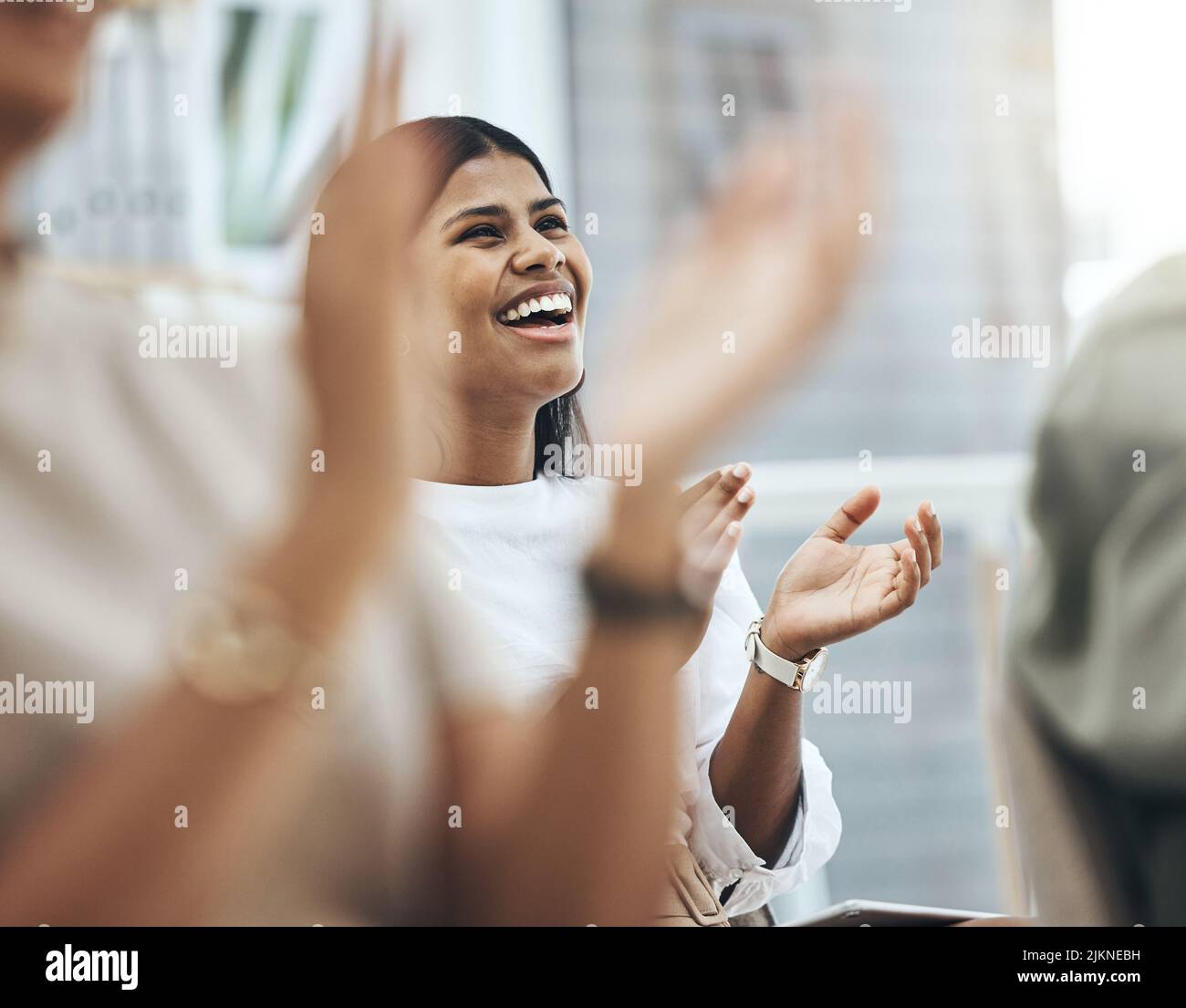 Feeling inspired. a group of people clapping and smiling during a ...