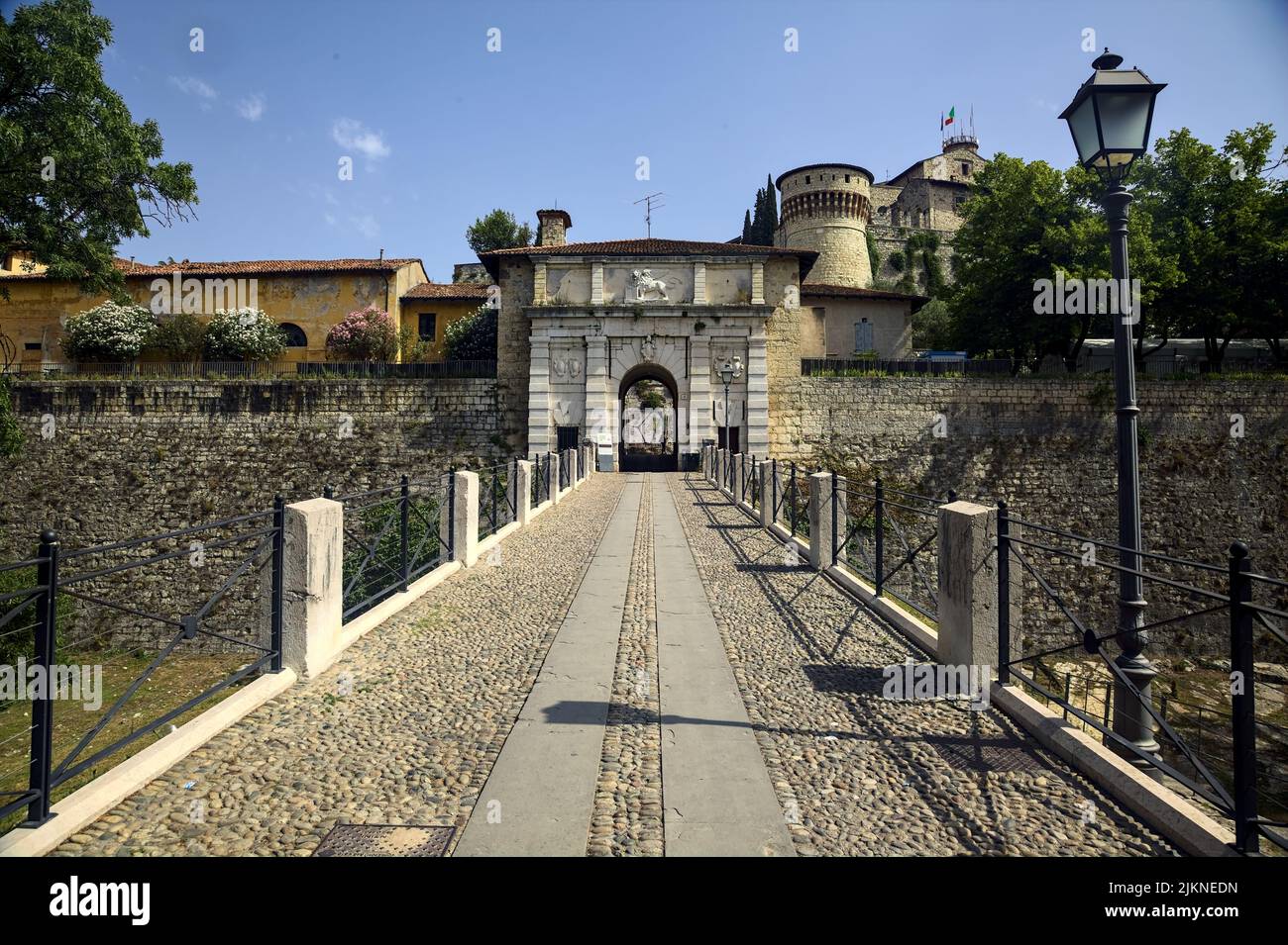 Bridge that leads to the gate of Castello di Brescia on a sunny day ...