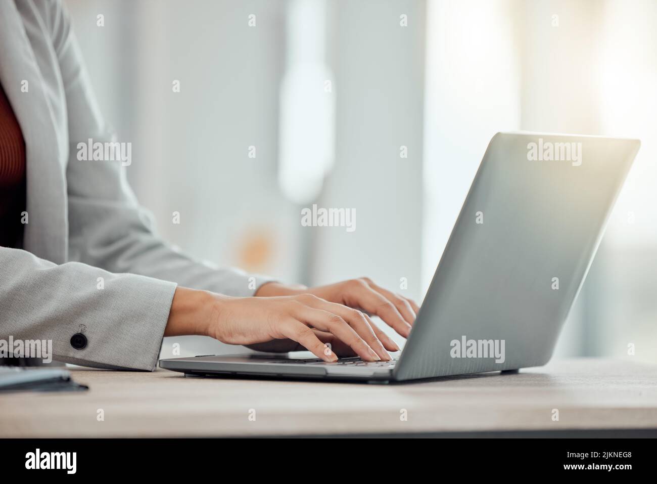 Closeup hands of manager typing on laptop, reviewing employee contracts ...