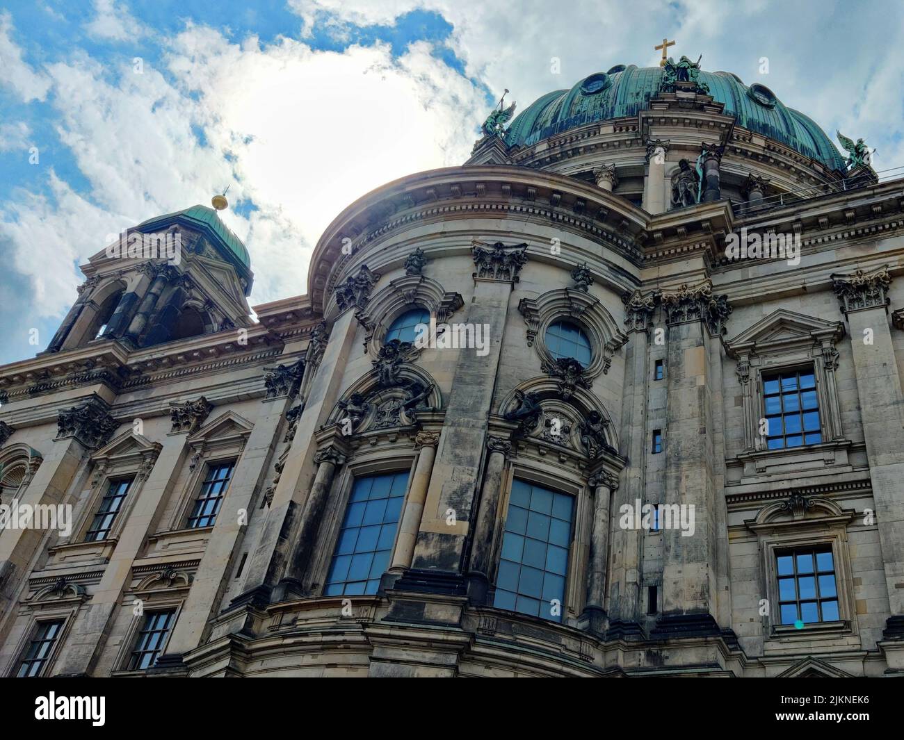 A low angle shot of Berliner Dom (Berlin Cathedral) against blue cloudy ...