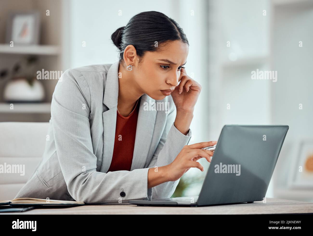 Serious, concentrating and African business woman reading an email ...