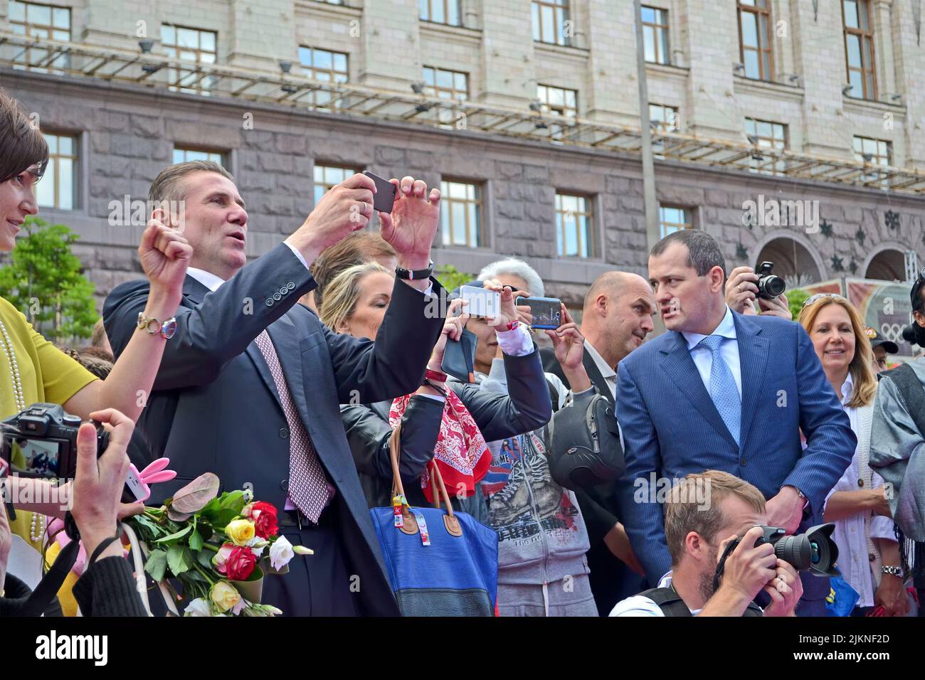 Ukrainian pole vaulter Sergey Bubka making photo by camera. Celebration ...