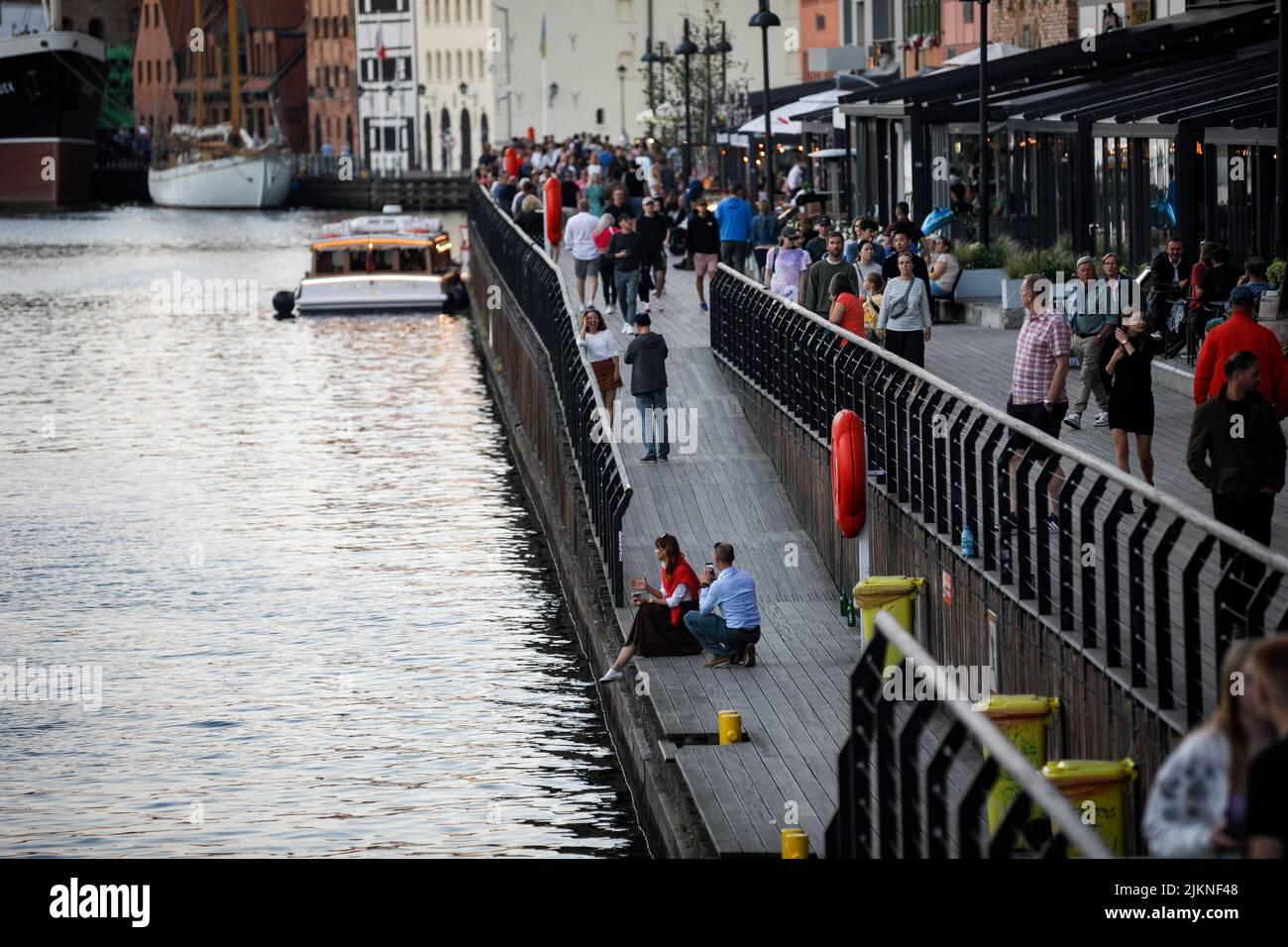 Gdansk, Poland. 01st Aug, 2022. People walk the Motlava river shore in ...