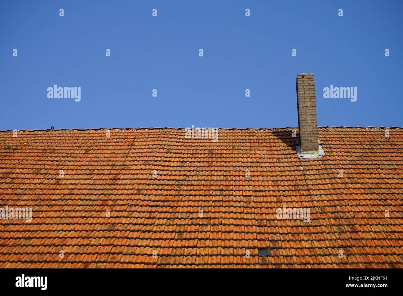 A beautiful shot of a red roof of a house and a chimney Stock Photo - Alamy