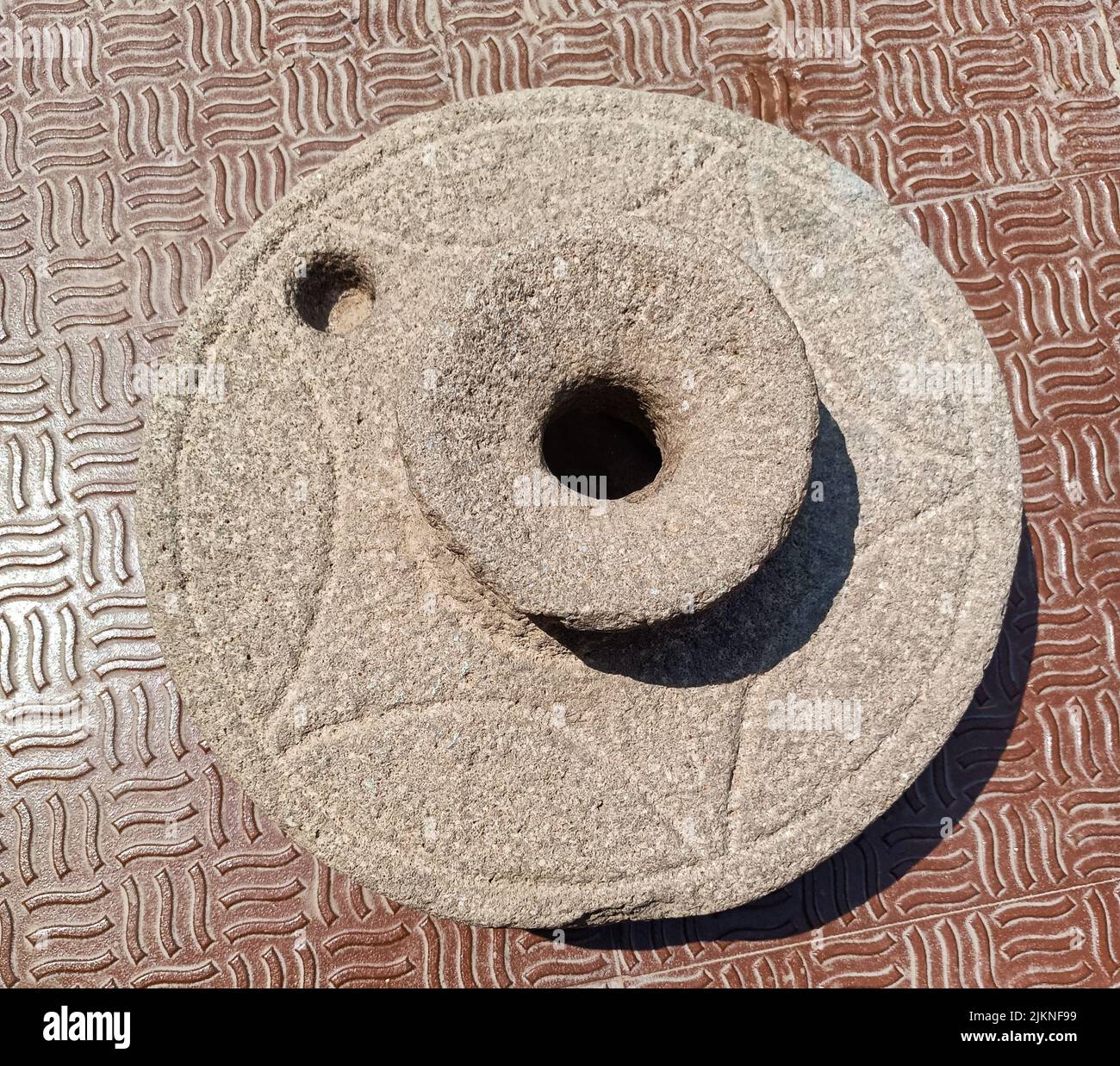ancient hand mill or quern stone, grinds the grain into flour. Old ...