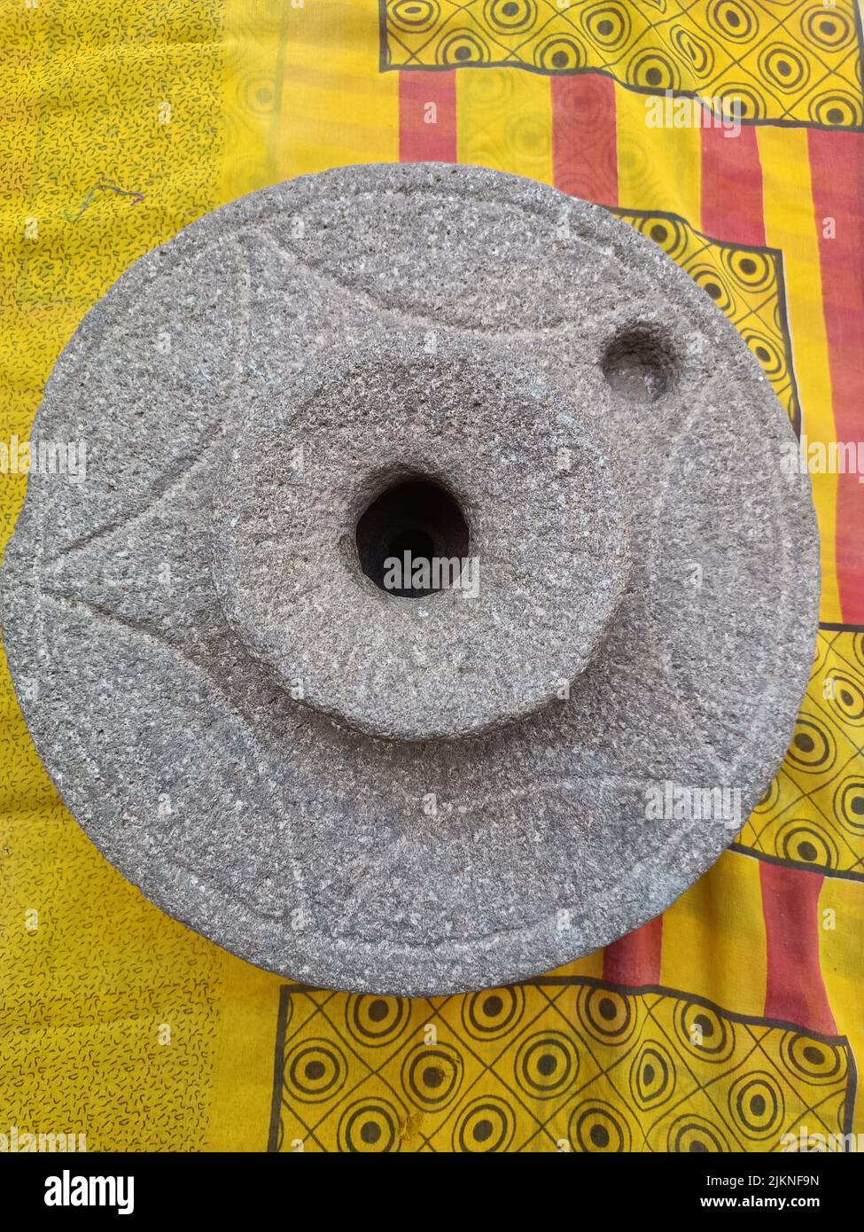 ancient hand mill or quern stone, grinds the grain into flour. Old ...