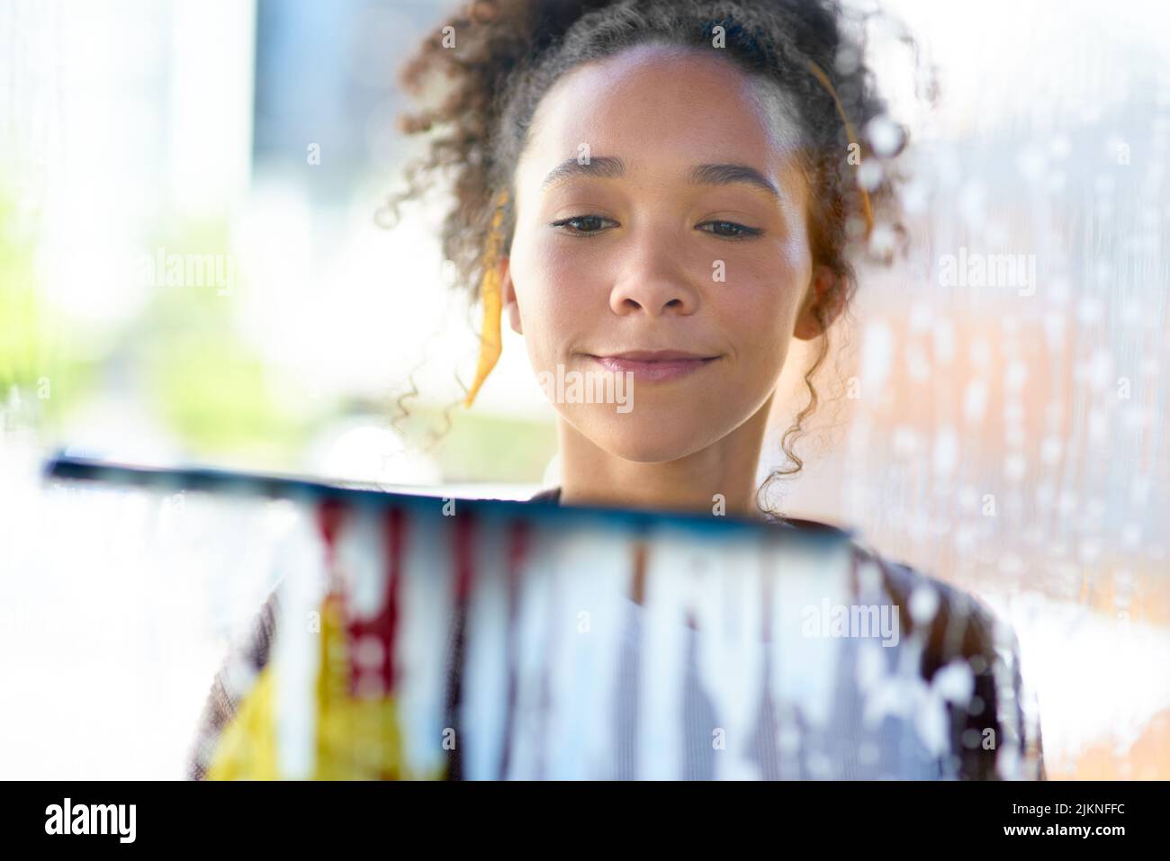 Young woman washing windows hi-res stock photography and images - Alamy