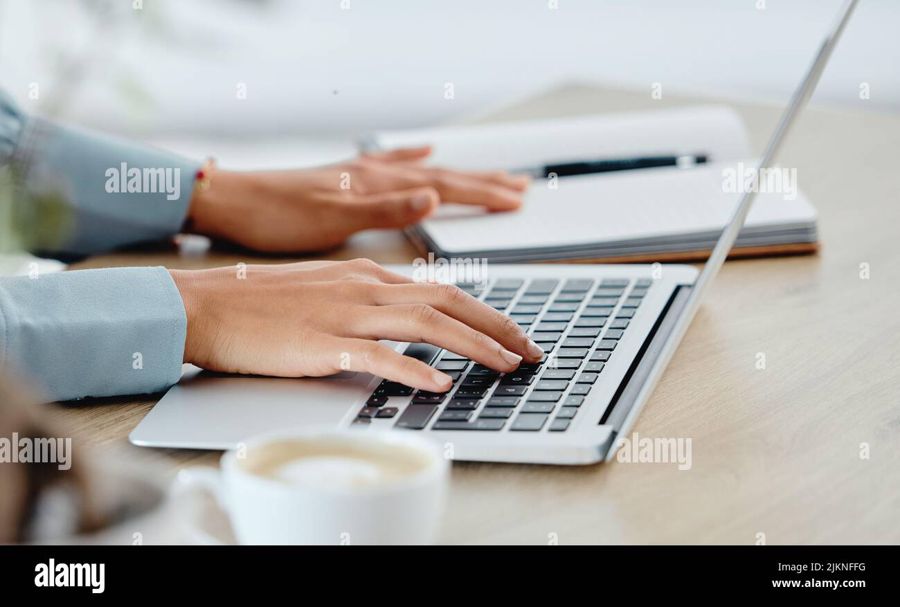 Social media creative typing on laptop, reading book and planning ...