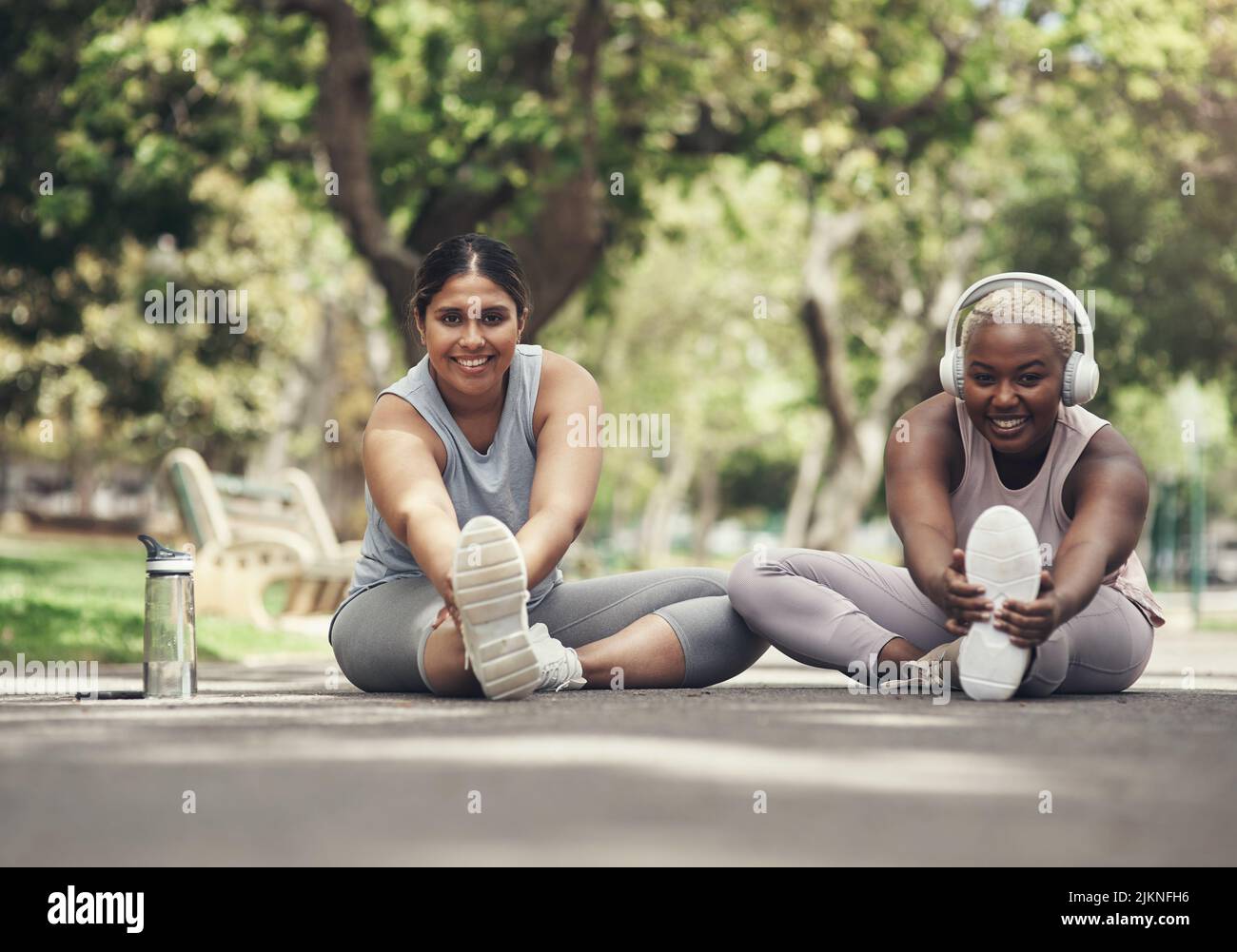 I love working out with friends. two young woman taking a break during ...