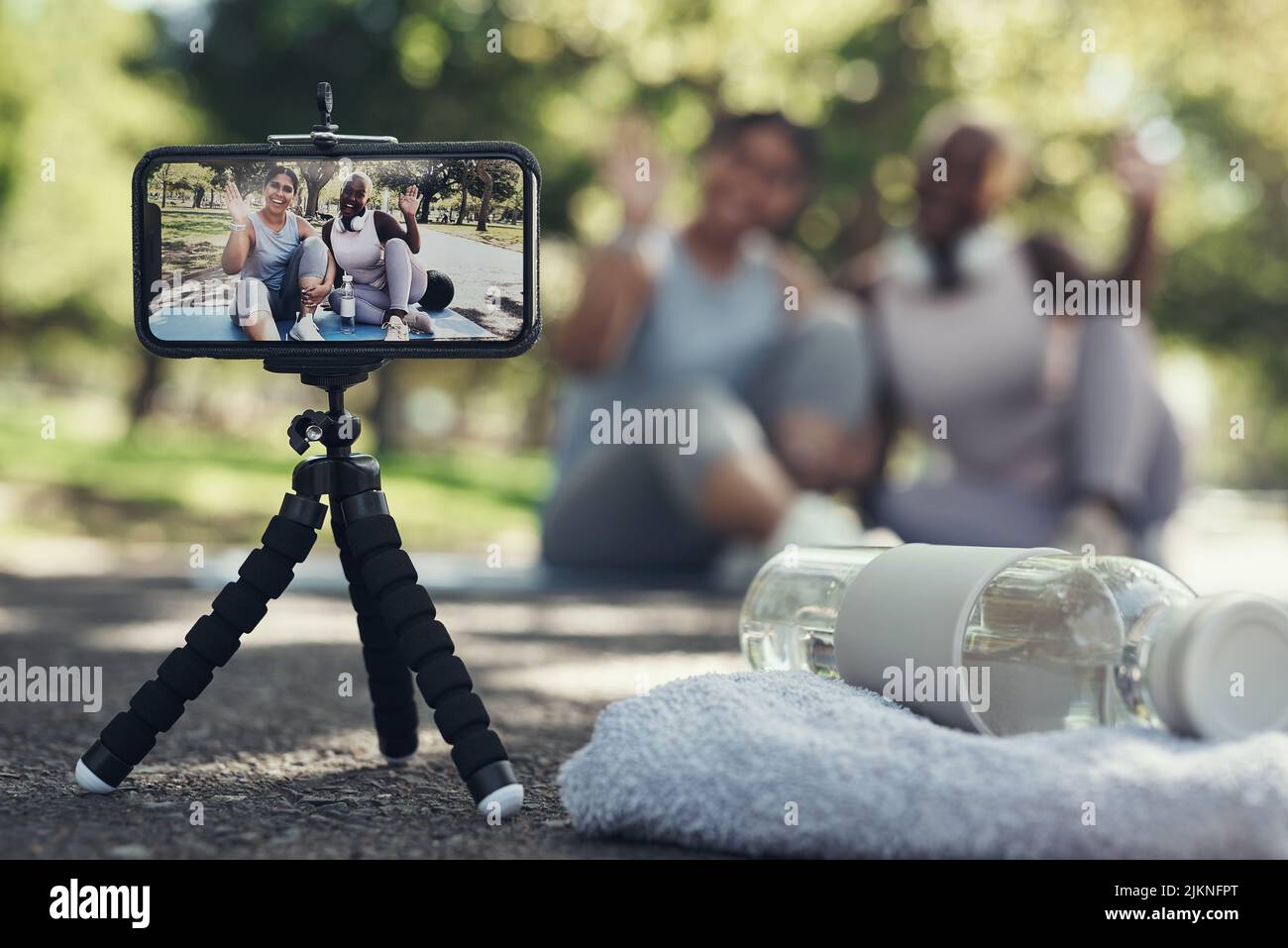 Were finally filming our workout routine. two female friends taking a ...