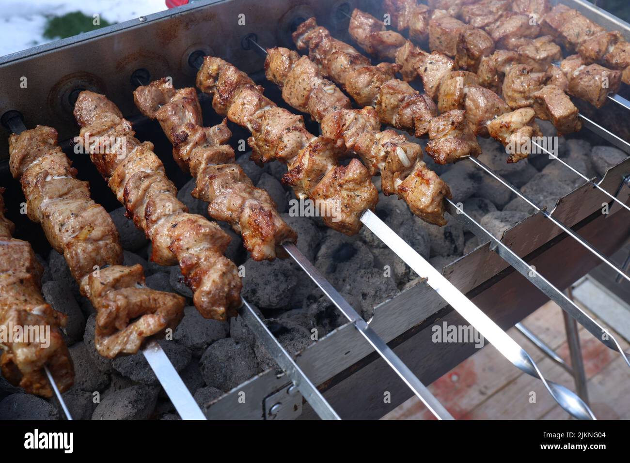 Roasted meat cooked at barbecue with smoke Stock Photo - Alamy