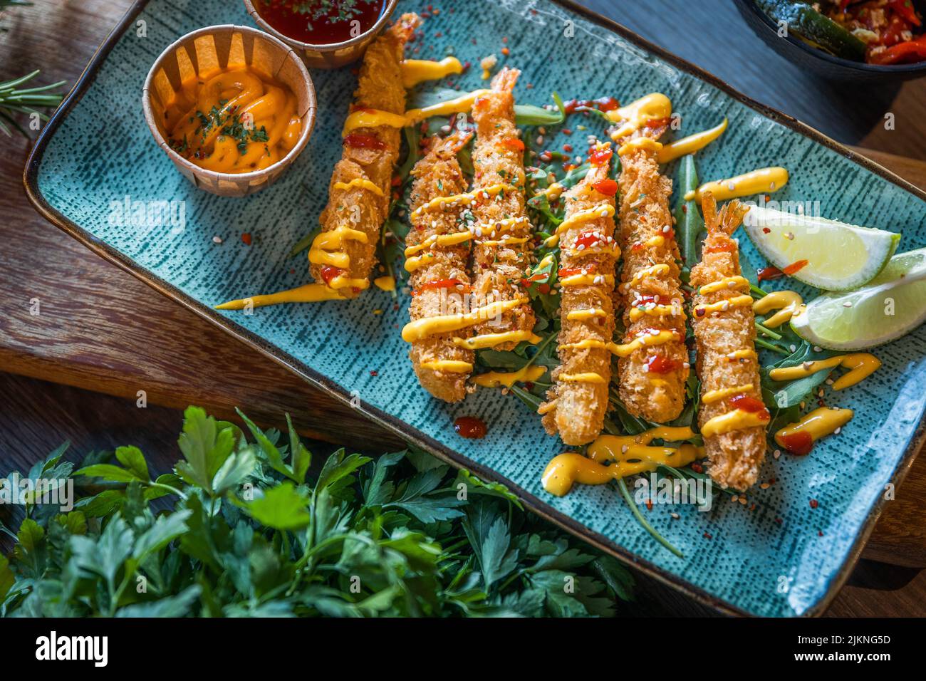 A top view of shrimp tempura topped with sauces and lime Stock Photo ...