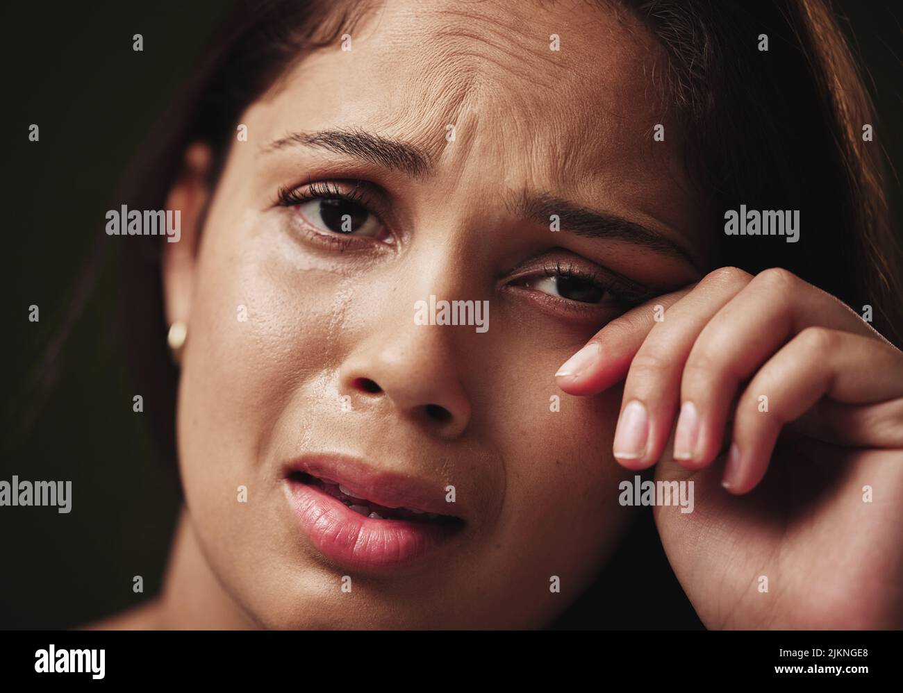 No Shoulder To Cry On Cropped Portrait Of An Attractive Young Woman Crying Against A Dark