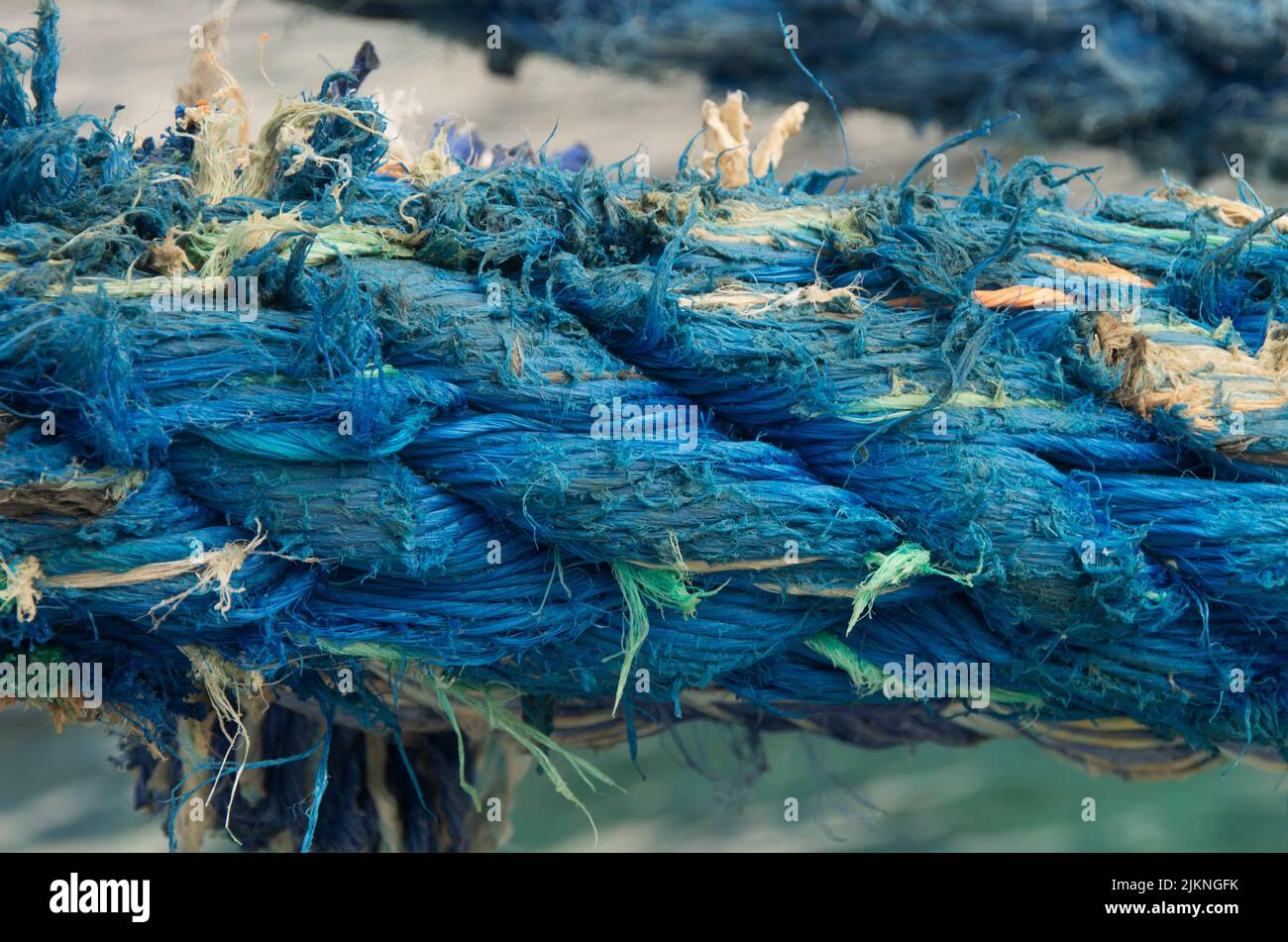 A close up of one of the ropes used to tie down a cruise ship at port ...