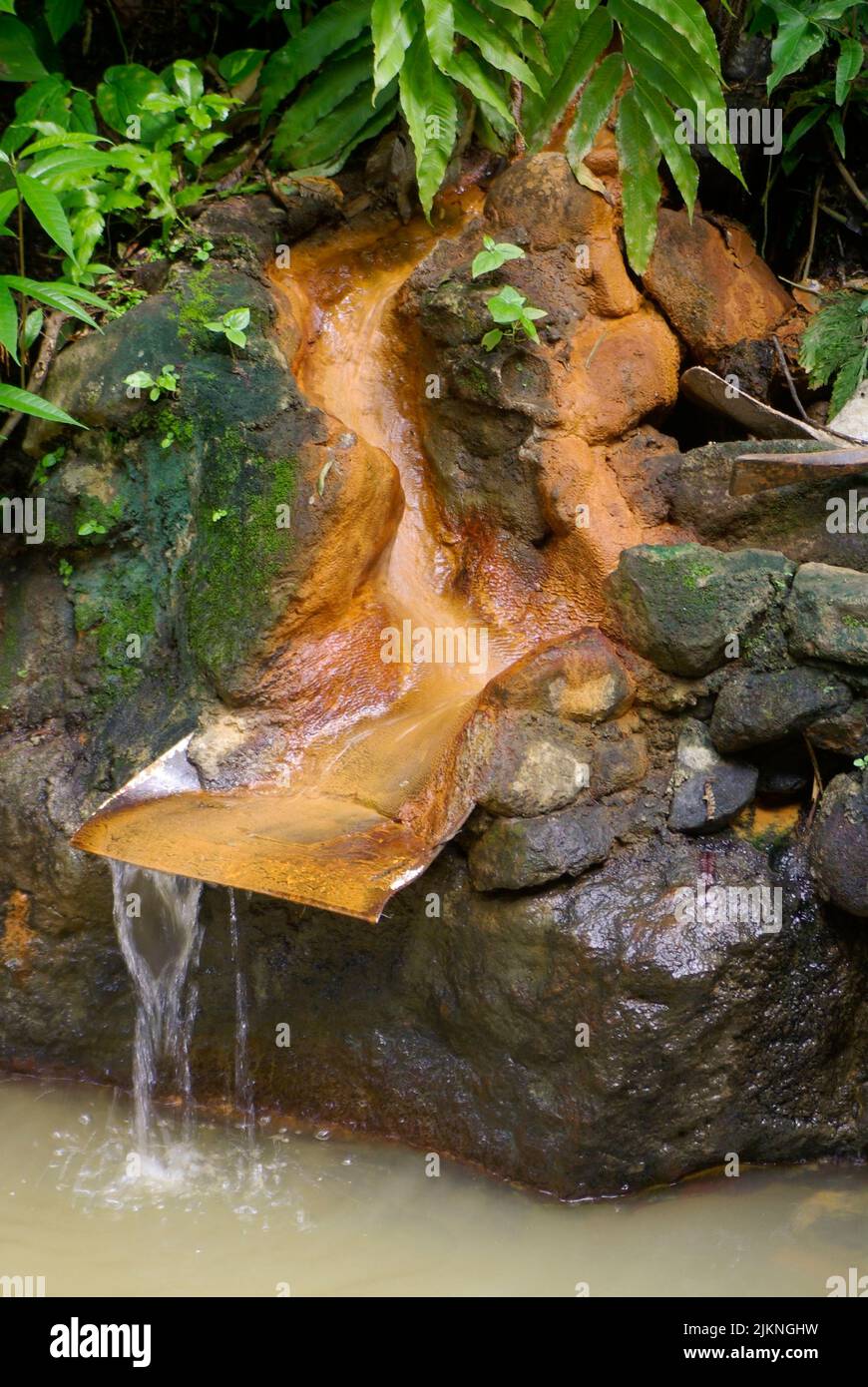 Water flows down a slide from underground volcanic springs Stock Photo ...