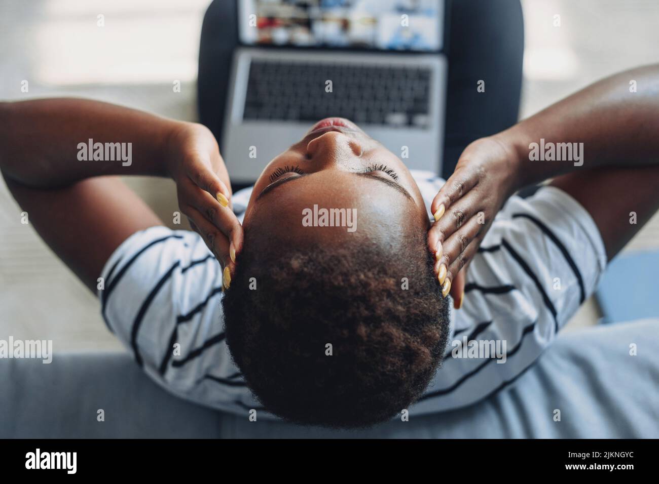 Top view african american woman sitting on the floor grabbing head ...