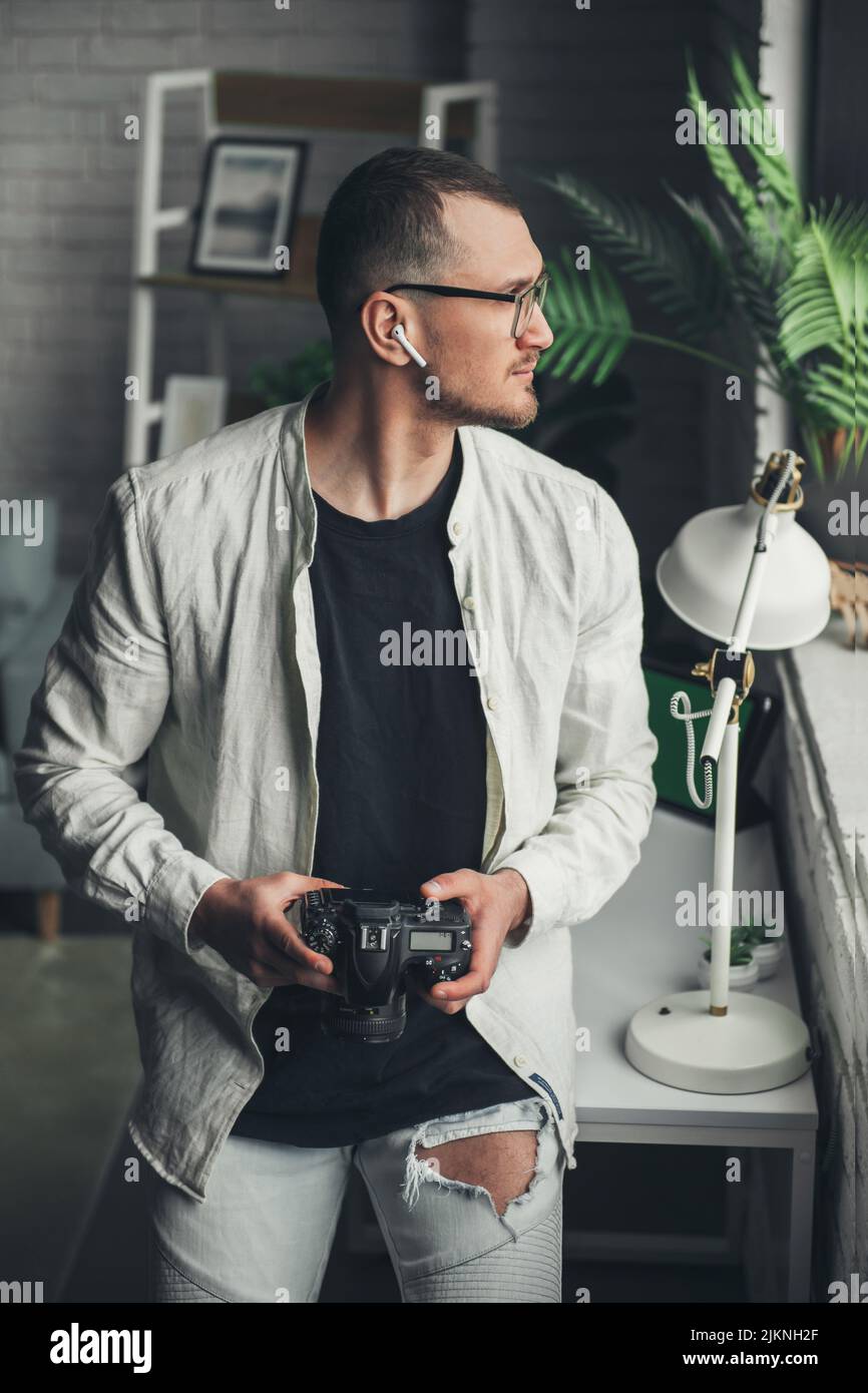 Portrait of professional man photographer standing in the office ...