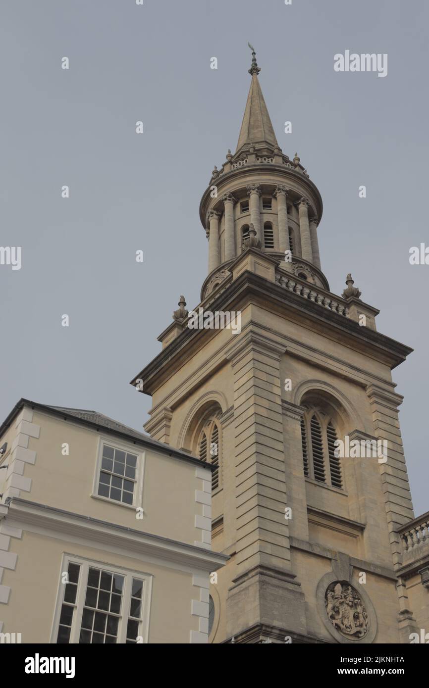 A vertical low angle shot of a beige brick tower with an overcast in ...