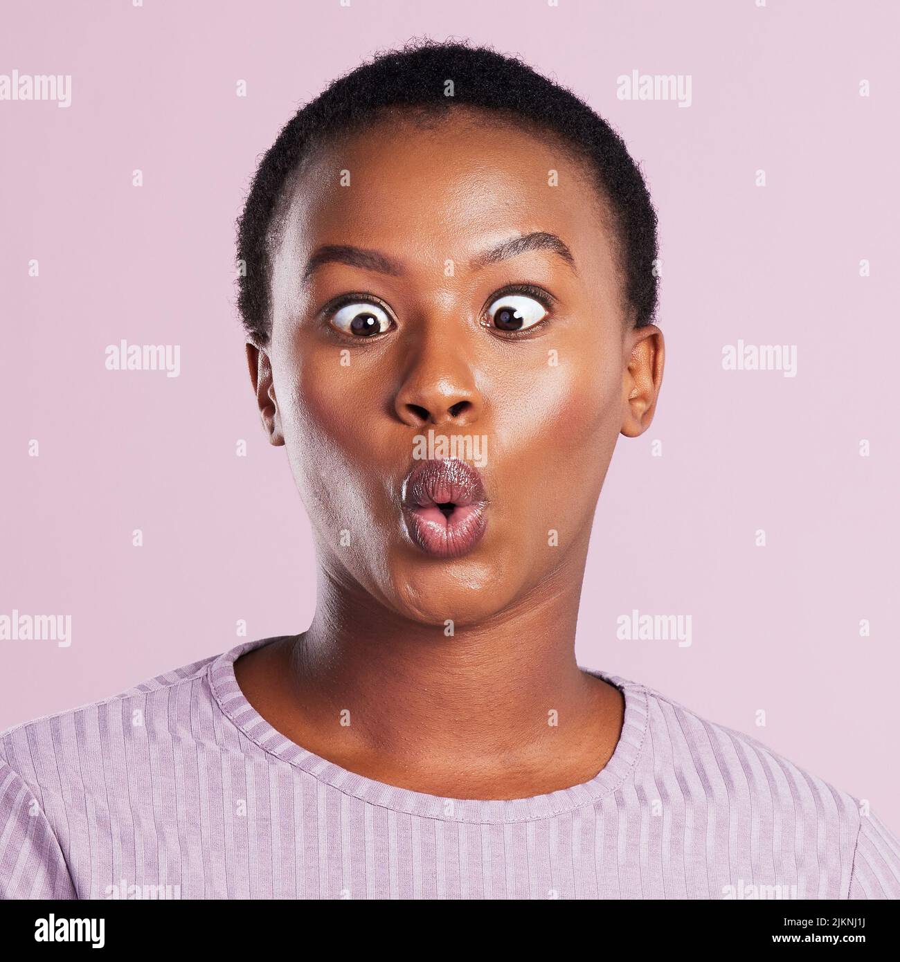 Embrace your silly side. Studio shot of a young woman making a silly ...