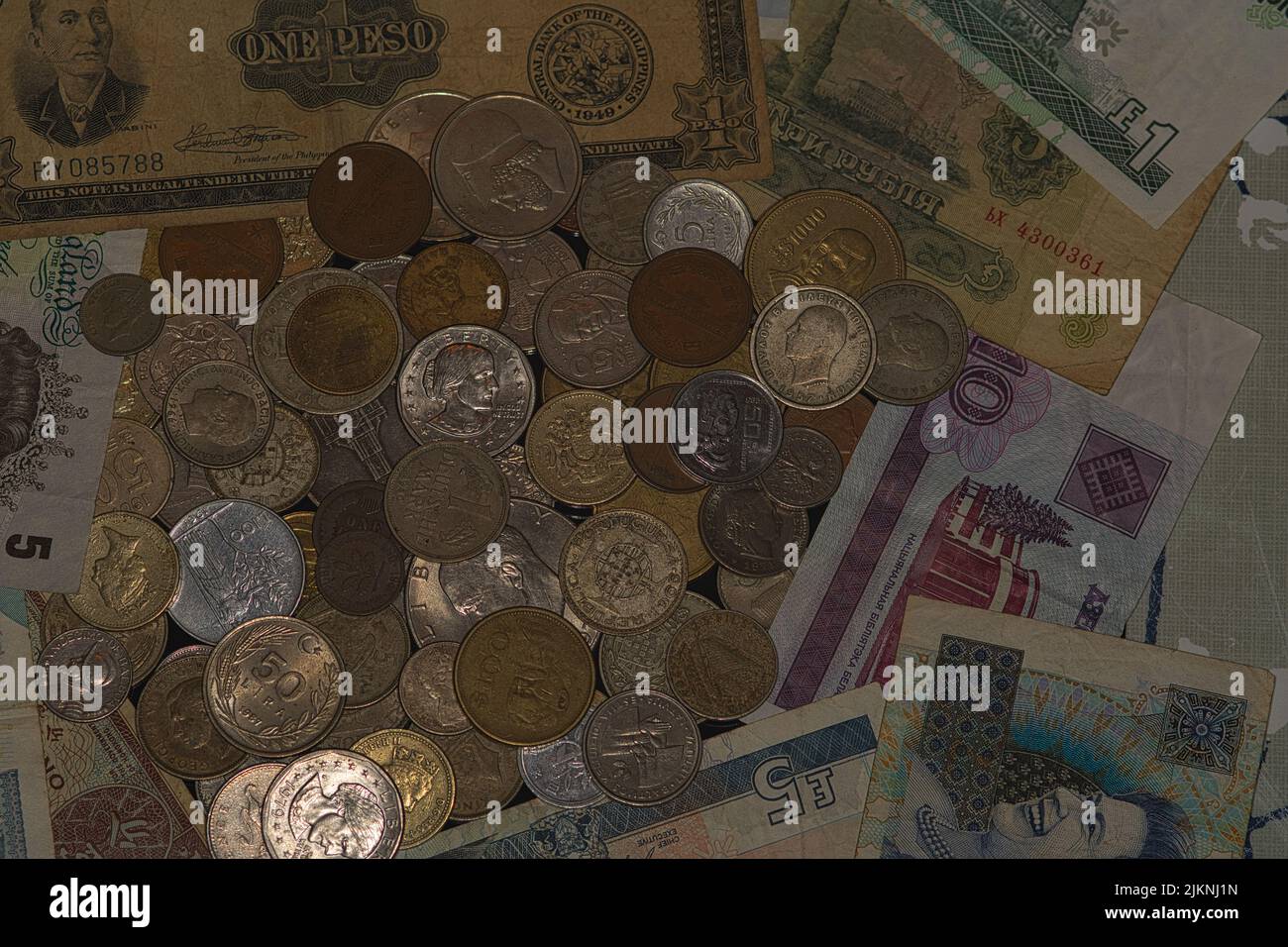 A top view of a stack of old coins and paper money - numismatics Stock ...