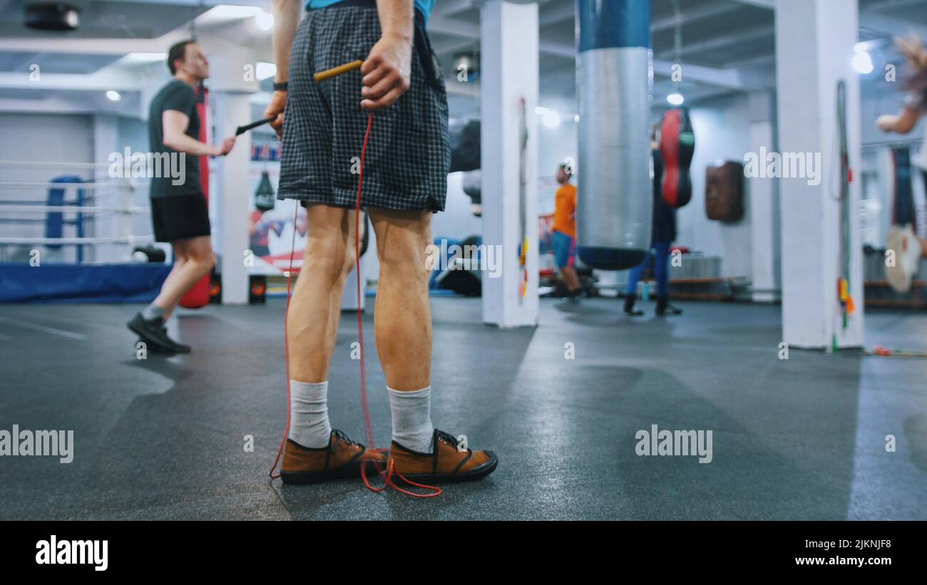 A man jumping over the rope in the gym Stock Photo - Alamy
