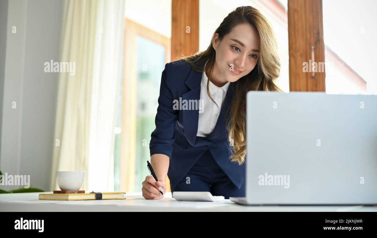 Beautiful and charming Asian businesswoman or female marketing manager ...